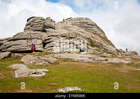 People scrambling on the granite tor of Haytor, Dartmoor national park ...