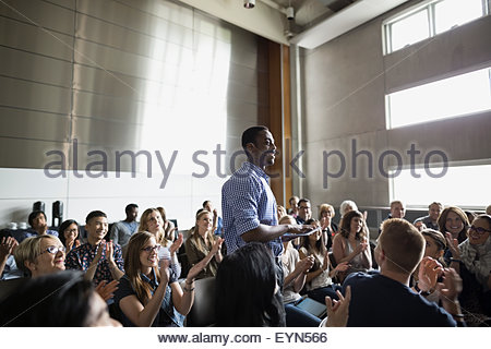 Professor giving lecture among auditorium audience Stock Photo - Alamy