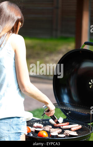 beautiful woman cooks delicious food in the kitchen Stock Photo - Alamy