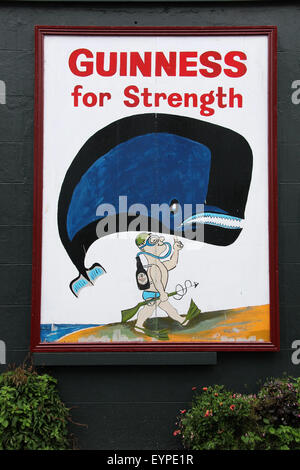 Irish pub with Guinness ad poster in both Gaelic and English, Kilkenny ...