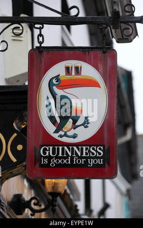 Irish pub with Guinness ad poster in both Gaelic and English, Kilkenny ...