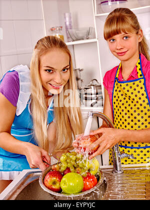 Vegetable, family and washing with a girl and mother cleaning a pepper ...