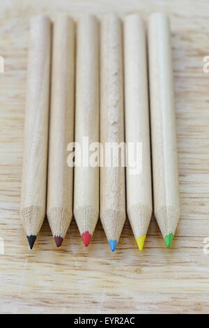 different colored wooden pencils on a wooden background Stock Photo - Alamy