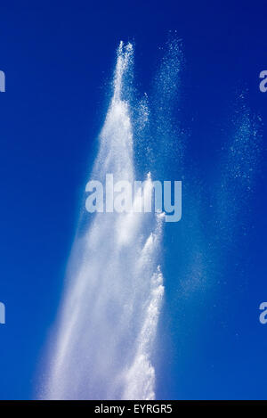 Water jet of a fountain against sunny blue sky in short-time-exposure ...
