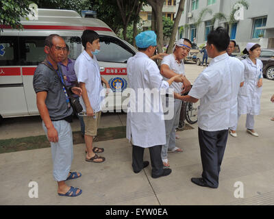 Menghai, China's Yunnan Province. 3rd Aug, 2015. Doctors examine an ...