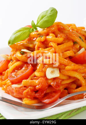 Thin spaetzle in garlic tomato sauce Stock Photo - Alamy