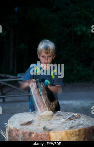 Child boy chopping wood alone, Splitting Logs Stock Photo - Alamy