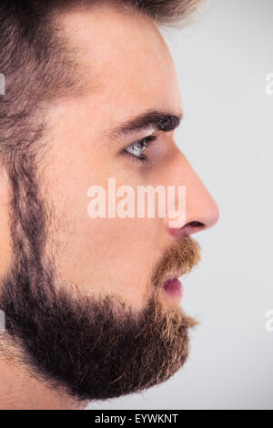 Side view of handsome unshaved man in fashionable clothes that riding ...