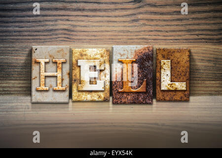The word "HELL" written in rusty metal letterpress type on a dark ...