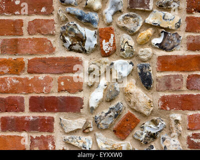 Detail of a flint and red brick wall, with circular patress wall tie ...