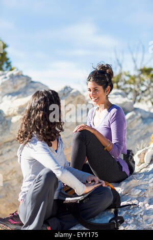 Two hikers talking together on a trail in the woods Stock Photo - Alamy