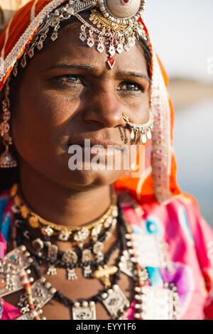 Close up of a women wearing traditional Pawra jewelry earrings. Bhil ...