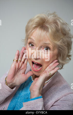 Senior woman shouting Stock Photo - Alamy
