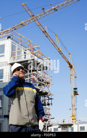 Construction site, workers and cranes Stock Photo - Alamy