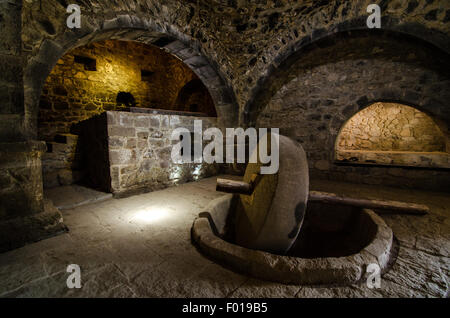 Exploring an ancient stone structure featuring a large grinding wheel ...