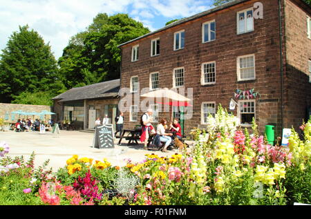Visitors relax by the shops and cafe at Sir Richard Arkwright's ...