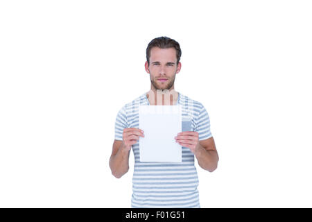 Young handsome man holding paper with question mark surprised with an ...