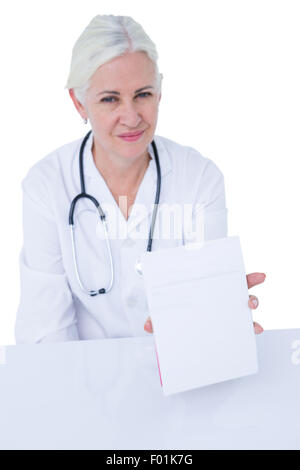 Doctor writing on a notepad at his desk Stock Photo - Alamy
