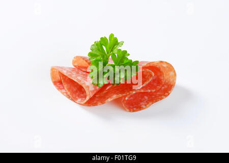 Thinly sliced salami - studio shot Stock Photo - Alamy