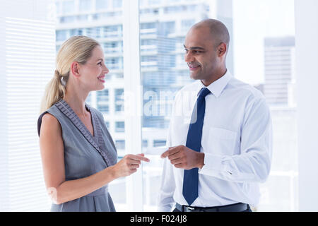 Businessman giving small paper sheet to his colleague Stock Photo - Alamy