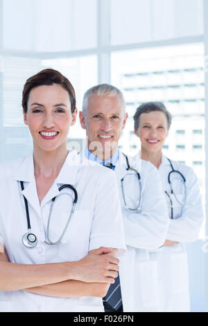 Portrait of three smiling medical colleagues with arms crossed Stock ...