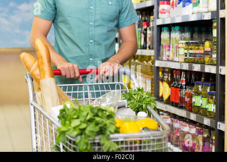 Man buy products with his trolley Stock Photo - Alamy