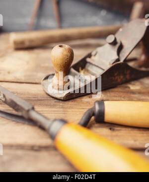 Od vintage hand tools on wooden background. Carpenter workplace Stock ...