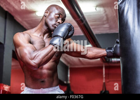 Young Bodybuilder boxing a bag Stock Photo - Alamy
