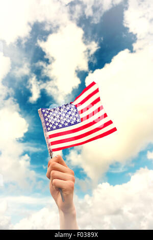 Composite image of hand waving american flag Stock Photo - Alamy