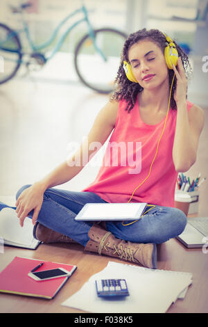 Young creative businesswoman listening to music Stock Photo - Alamy