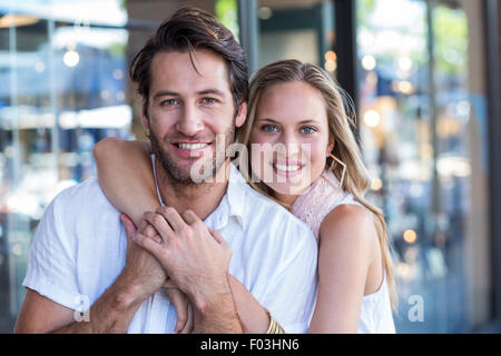 Smiling man putting arm around his girlfriend Stock Photo - Alamy