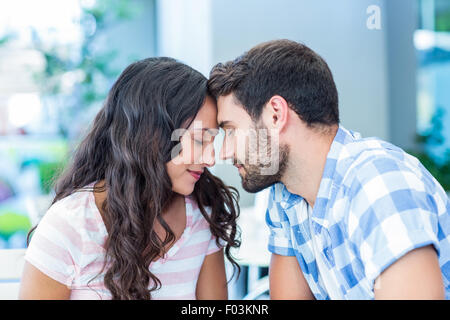 Cute couple putting foreheads against each others Stock Photo - Alamy