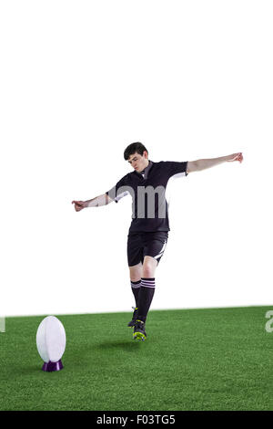 Rugby player doing a drop kick Stock Photo - Alamy