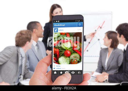 Hand holding smartphone mobile . Mixed media Stock Photo - Alamy