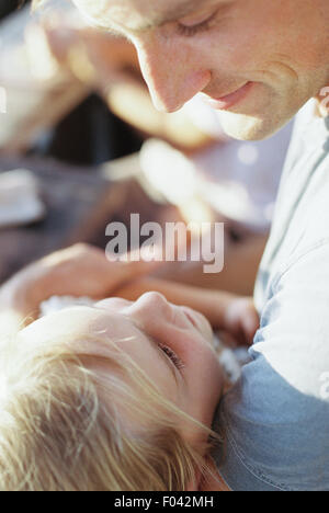 Loving family spending quality time together on a cozy bed Stock Photo ...