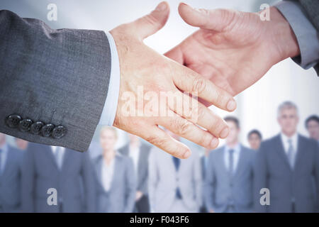Composite image of two people going to shake their hands Stock Photo ...