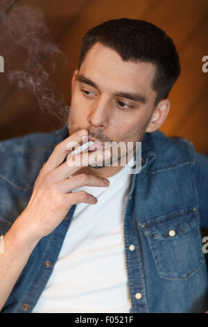 Young man smoking Stock Photo - Alamy