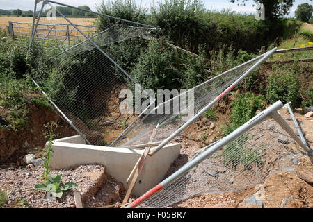 fencing around a drainage ditch that as blown over Stock Photo - Alamy