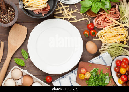 Cooking wooden utensils, empty plate, condiments and spices on stone ...