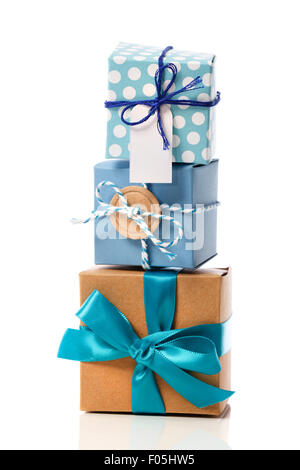 Pile of a small colored gift boxes with ribbons lies on a violet ...