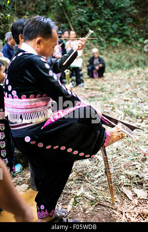 Hmong man shooting a hand made cross bow in a village in Chiang Mai ...