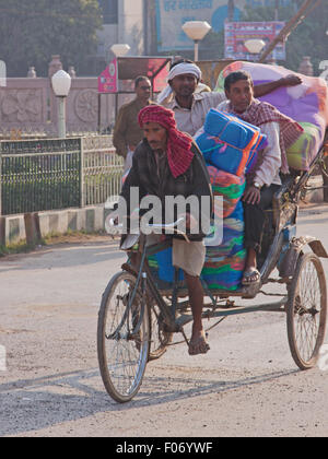 Tricycle rickshaw rider with heavy load. Nepal Stock Photo - Alamy