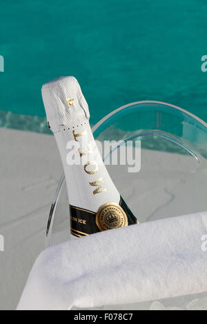 Champagne Moet white bottle and fresh fruits dish by the pool Stock ...