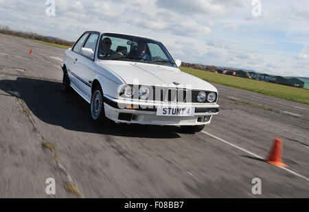 Slalom driving between cones in a BMW car Stock Photo - Alamy