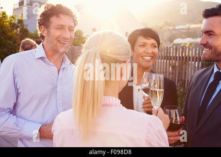 Colleagues drinking after work at a rooftop bar Stock Photo - Alamy