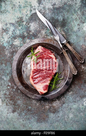 Raw striploin steak set, on black dark stone table background, top view ...