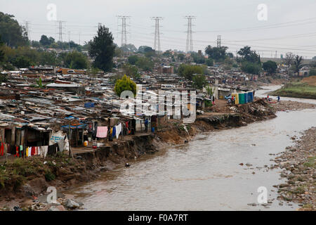 Shacks on the banks of the Jukskei river the morning after heavy rain ...