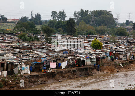 Shacks on the banks of the Jukskei river the morning after heavy rain ...