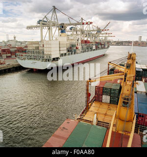 A cargo ship's bridge and control deck with antenna and spotlights ...