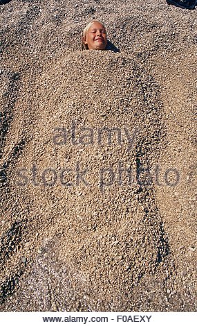 Young girl buried in sand Stock Photo: 17178065 - Alamy